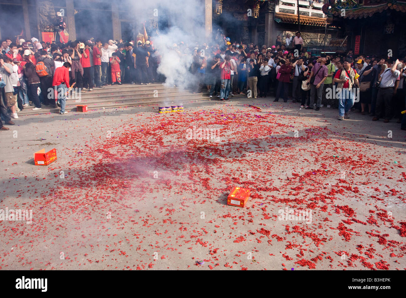Red firecrackers (fireworks) in the street outside Zhenlan Temple ...