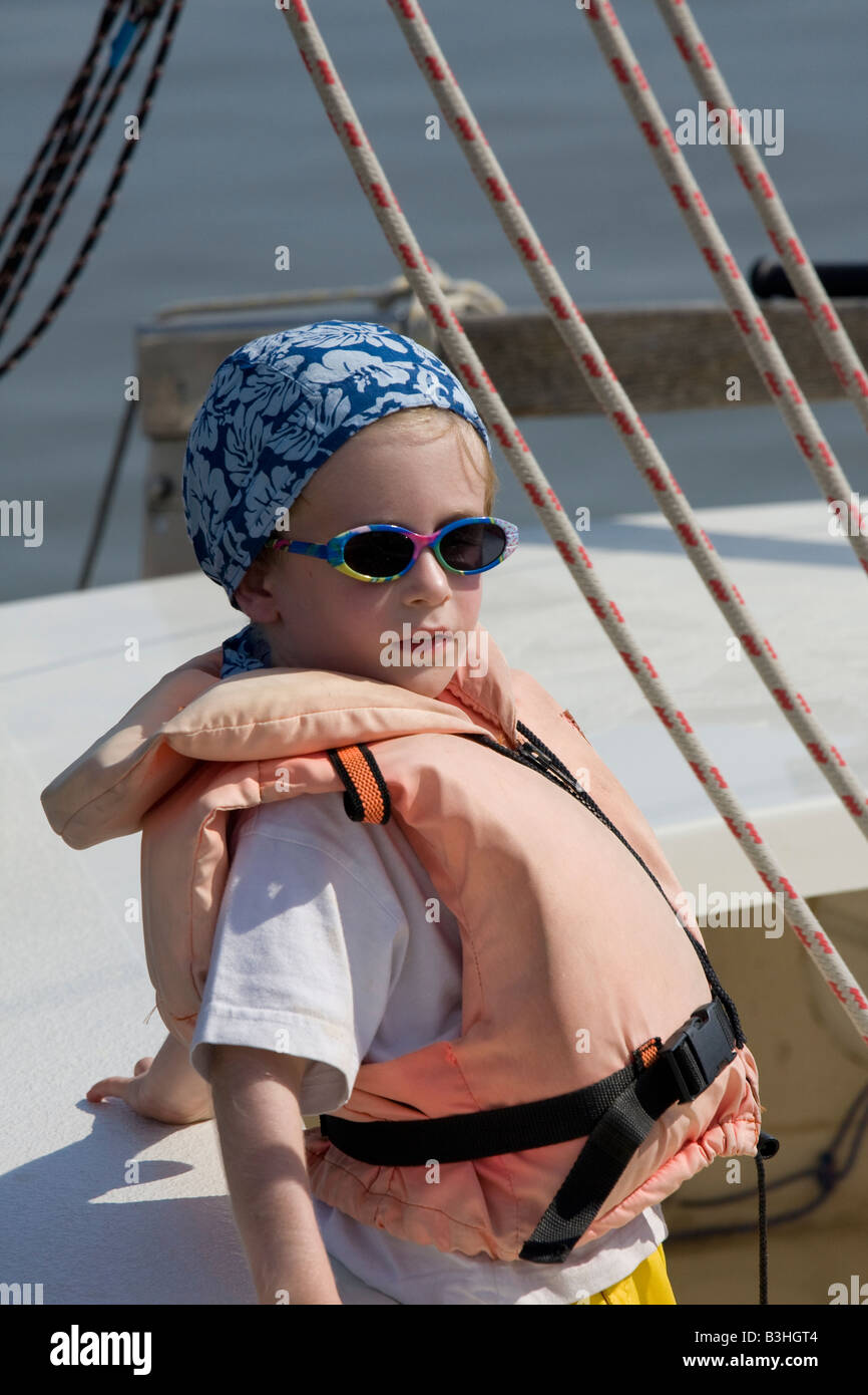 little boy with life jacket on sailing boat Stock Photo - Alamy