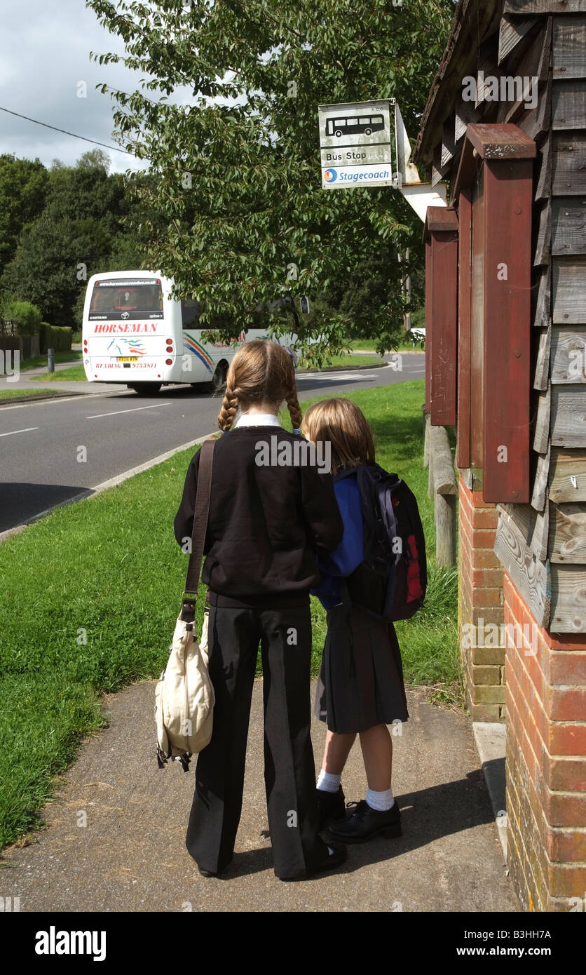 Children waiting at bus stop outside a bus shelter Stock Photo - Alamy