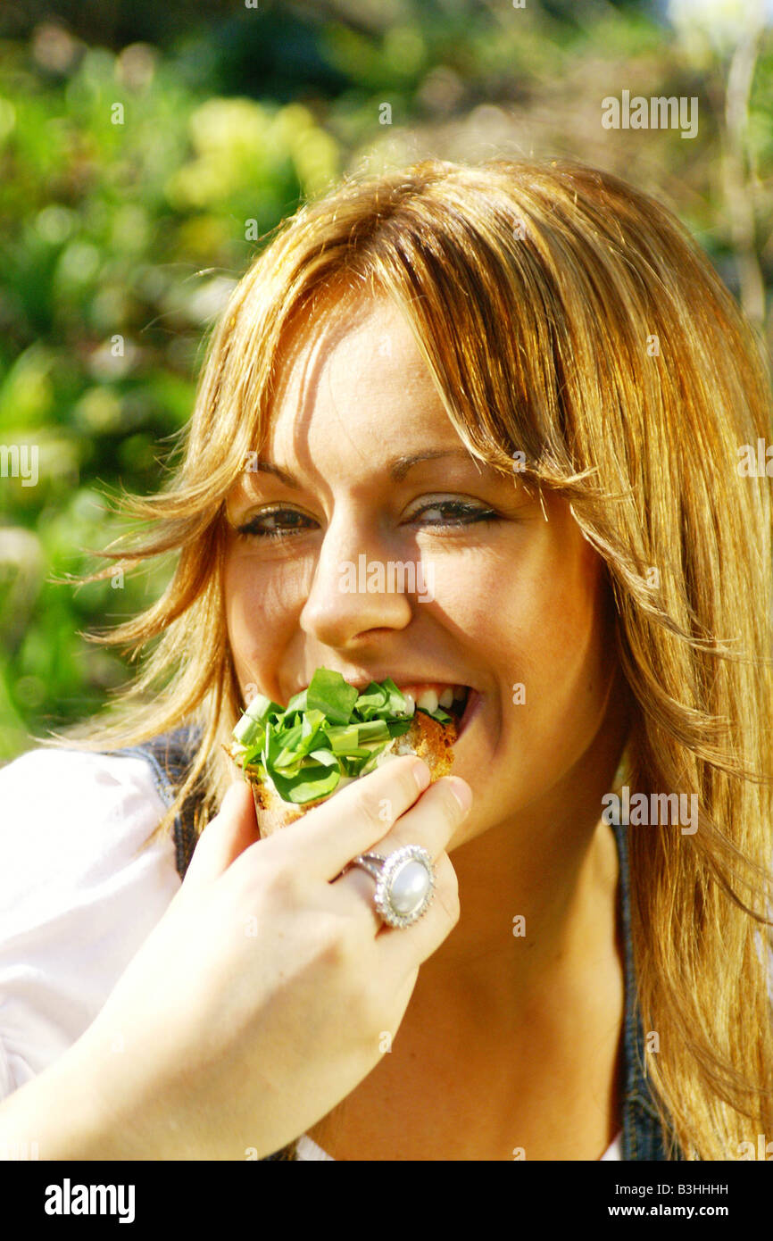Tanja eats bread and butter with wild garlic Stock Photo - Alamy