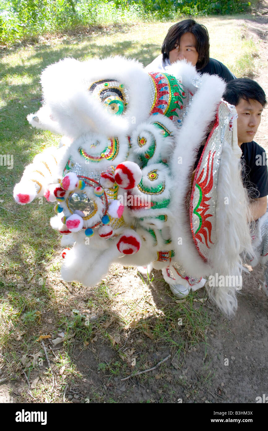 Asian dancers standing behind their ceremonial dragon puppet. Dragon ...