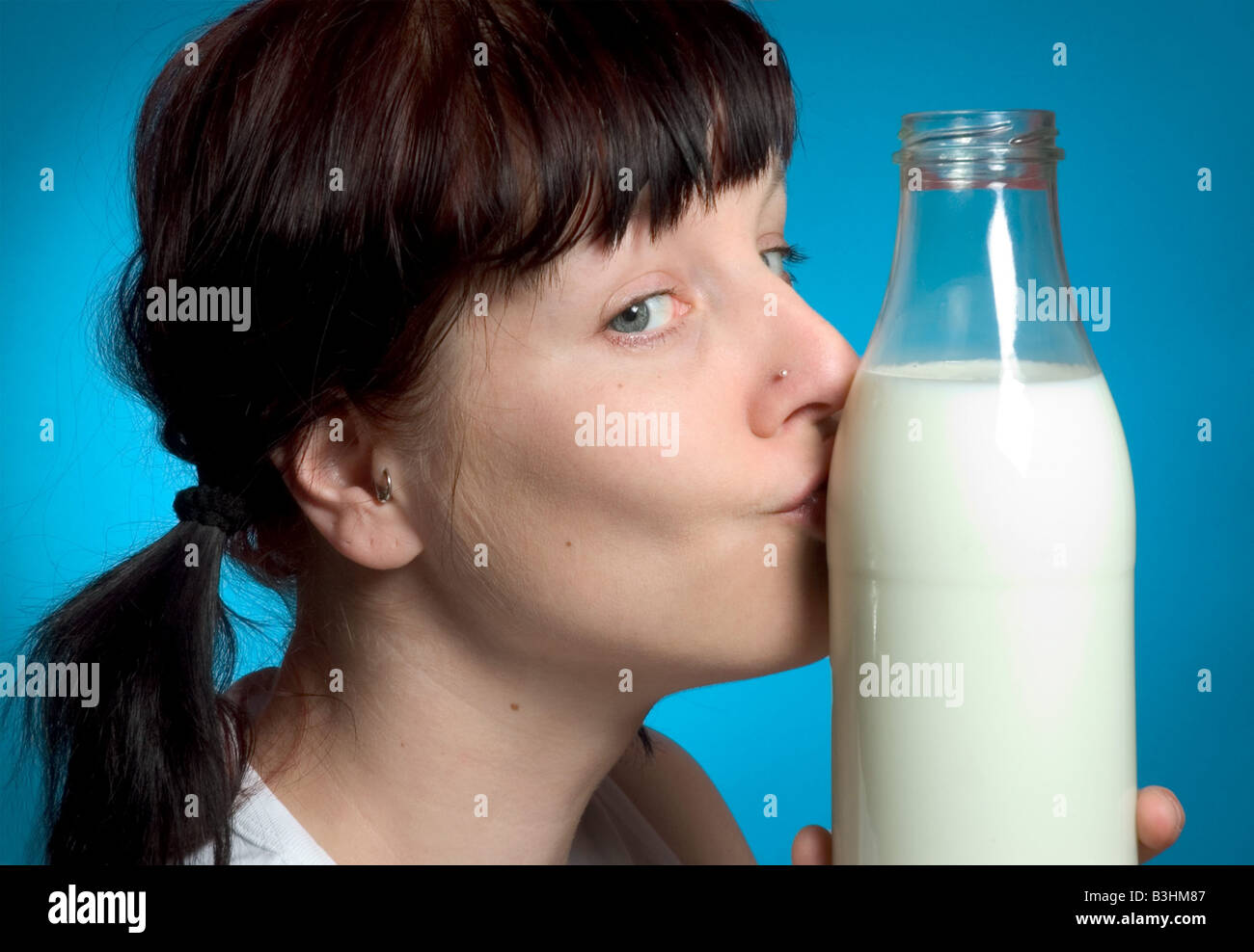 young woman with a milk bottle Stock Photo - Alamy
