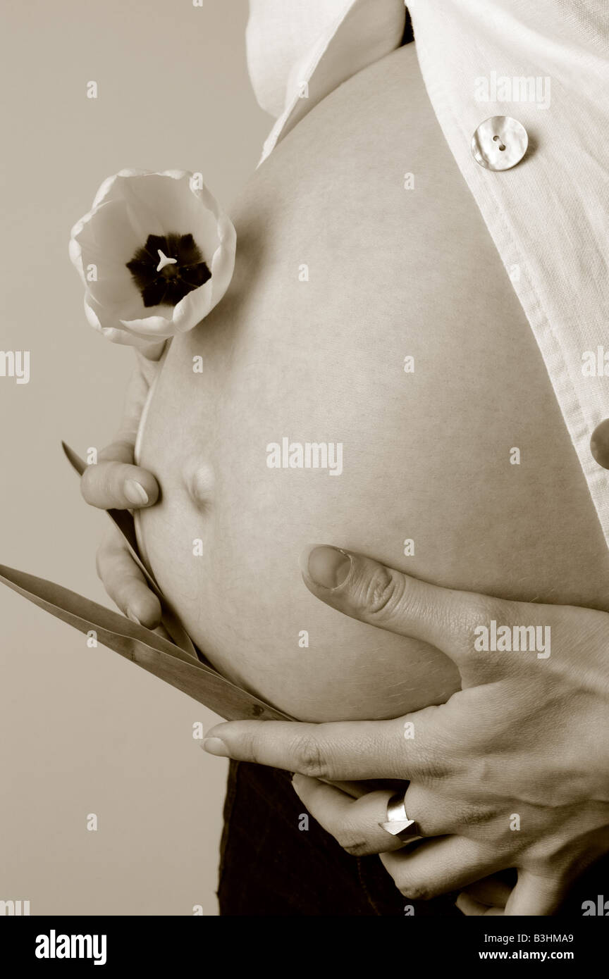 pregnant woman with a flower Stock Photo - Alamy