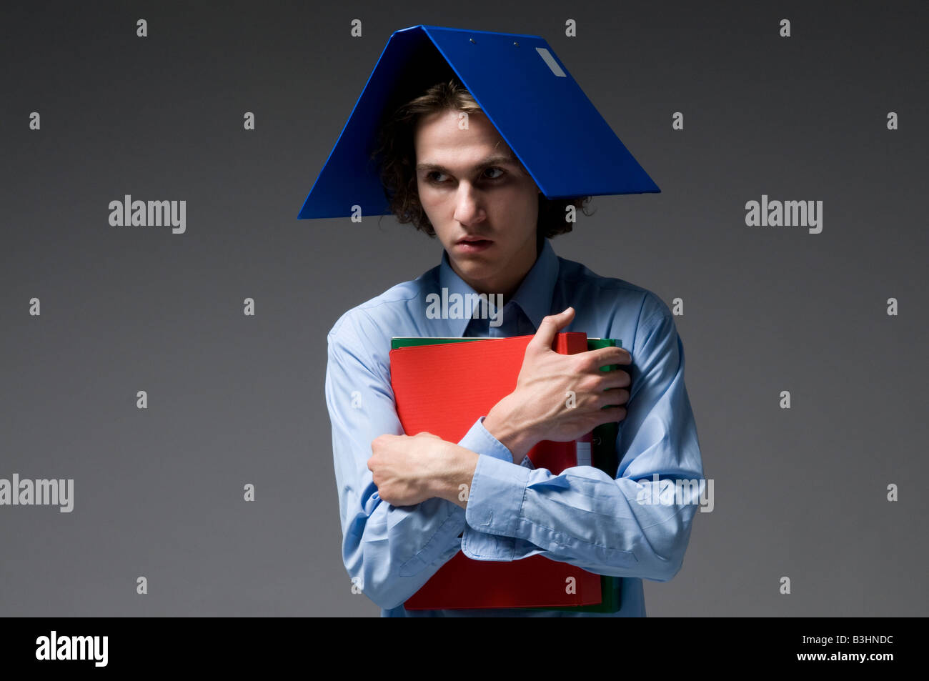Young man with files on his head Stock Photo - Alamy