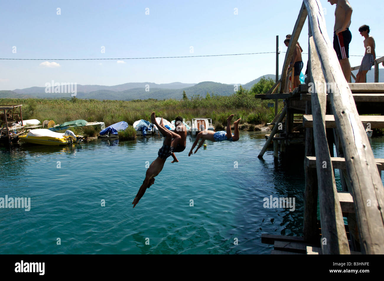 3 men jumping into a river in Turkey Stock Photo - Alamy