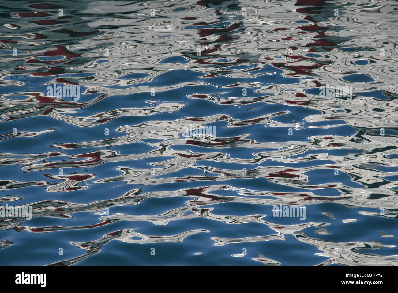 boat pattern reflection on water ripples in sea Stock Photo - Alamy