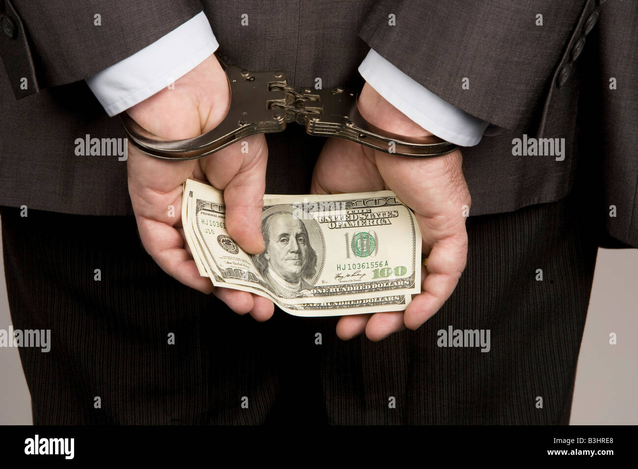 Dollar banknotes and handcuffs Stock Photo - Alamy
