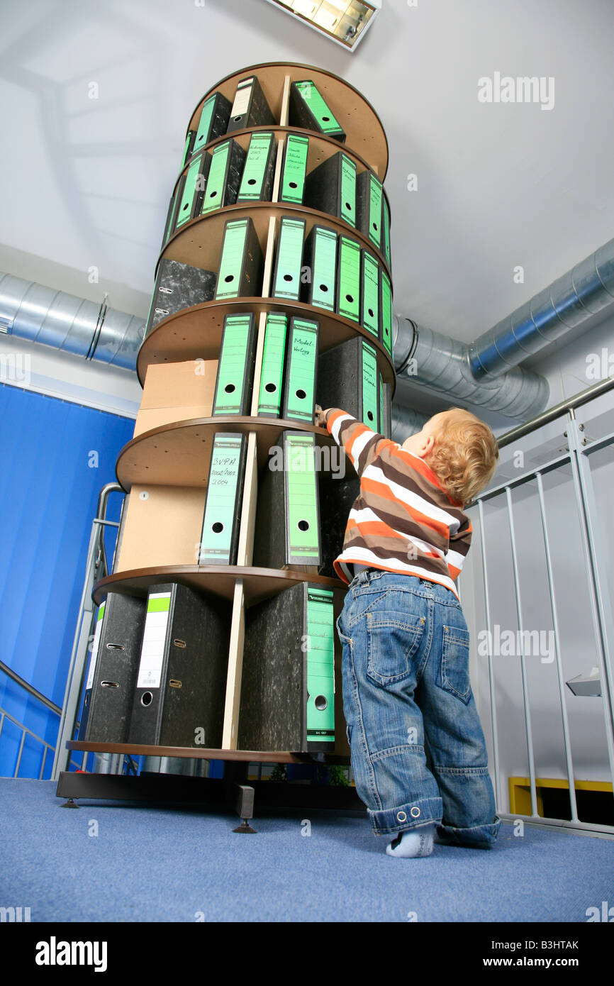 small boy in front of a folder storage rack in the office Stock Photo ...