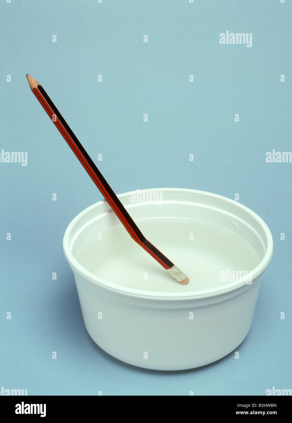Refraction of light causes a pencil in water to look bent Stock Photo ...