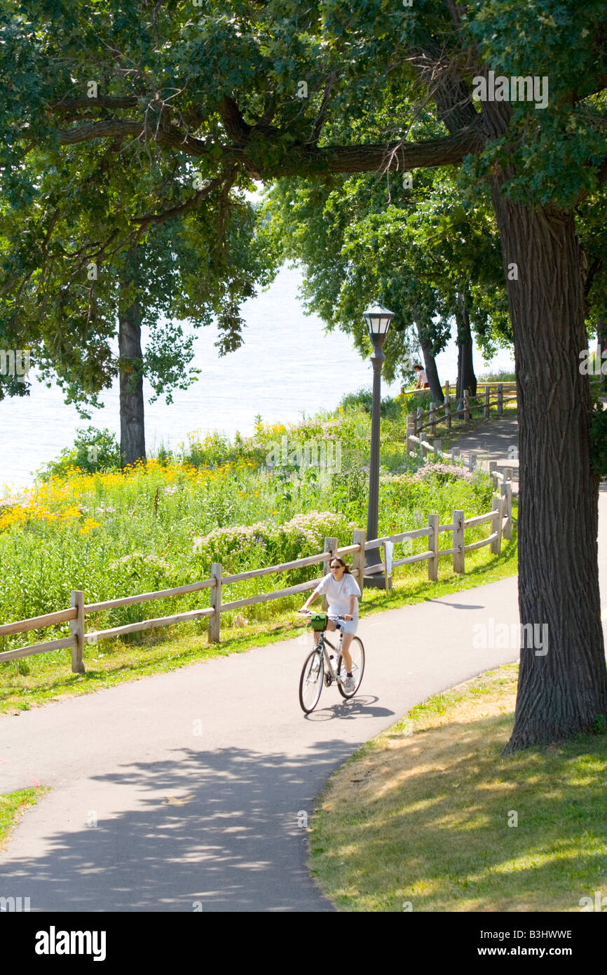 Bicycler enjoying ride among the many paths of the Lake Phalen Park. St ...