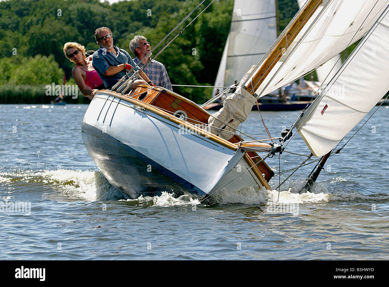 A Broads cruiser racing during Wroxham Regatta Week Stock Photo - Alamy