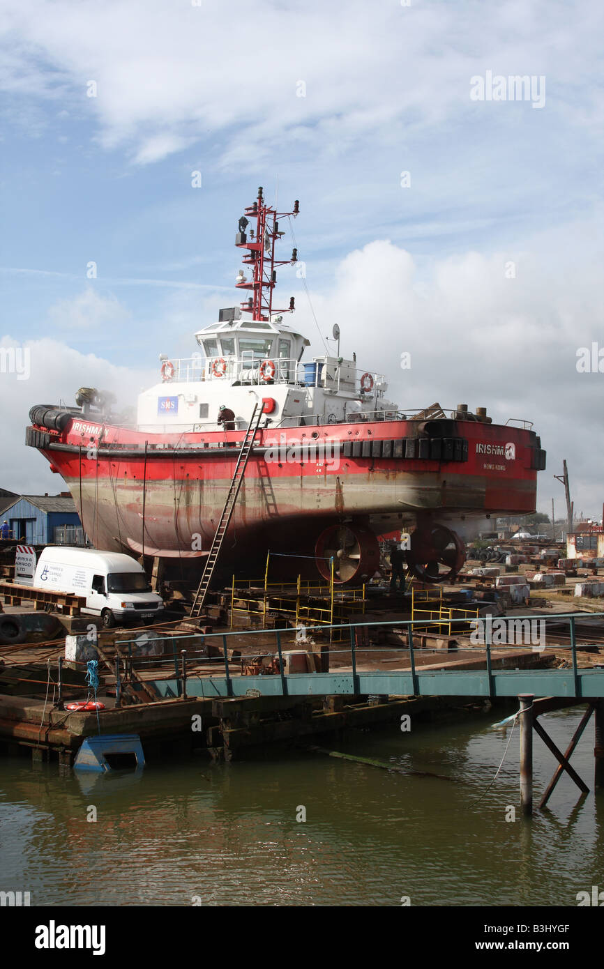 A fishing trawler undergoing maintenance work on a slipway at Grimsby ...