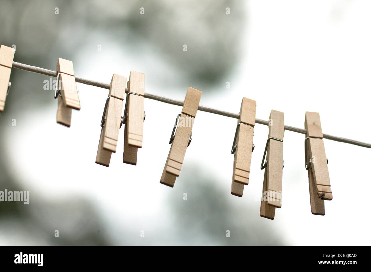 Close-up of clothes pins hanging on a line Stock Photo - Alamy