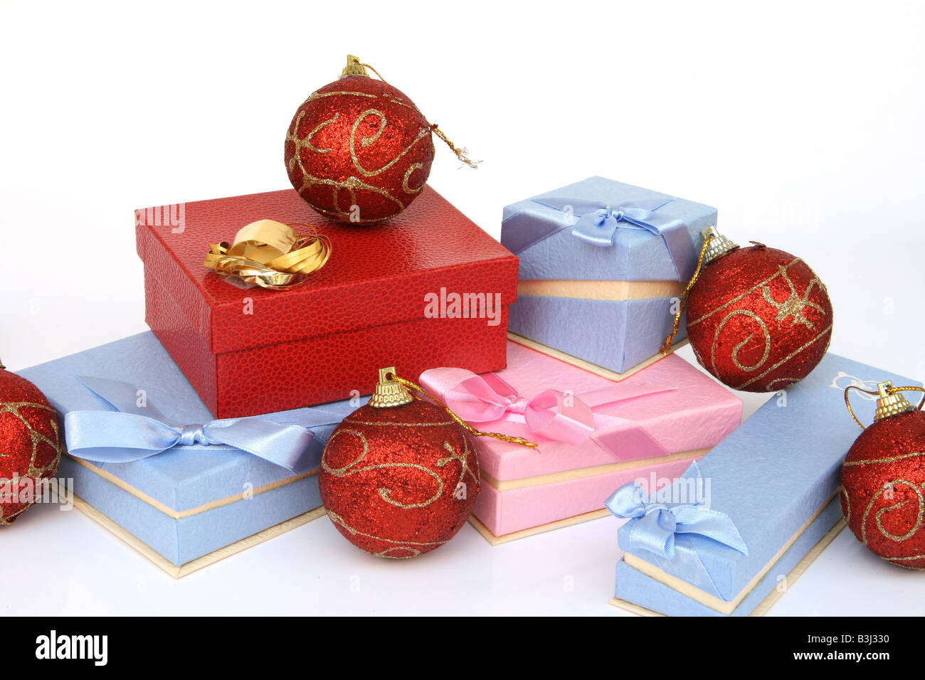 stack of christmas gifts with red xmas balls isolated Stock Photo - Alamy