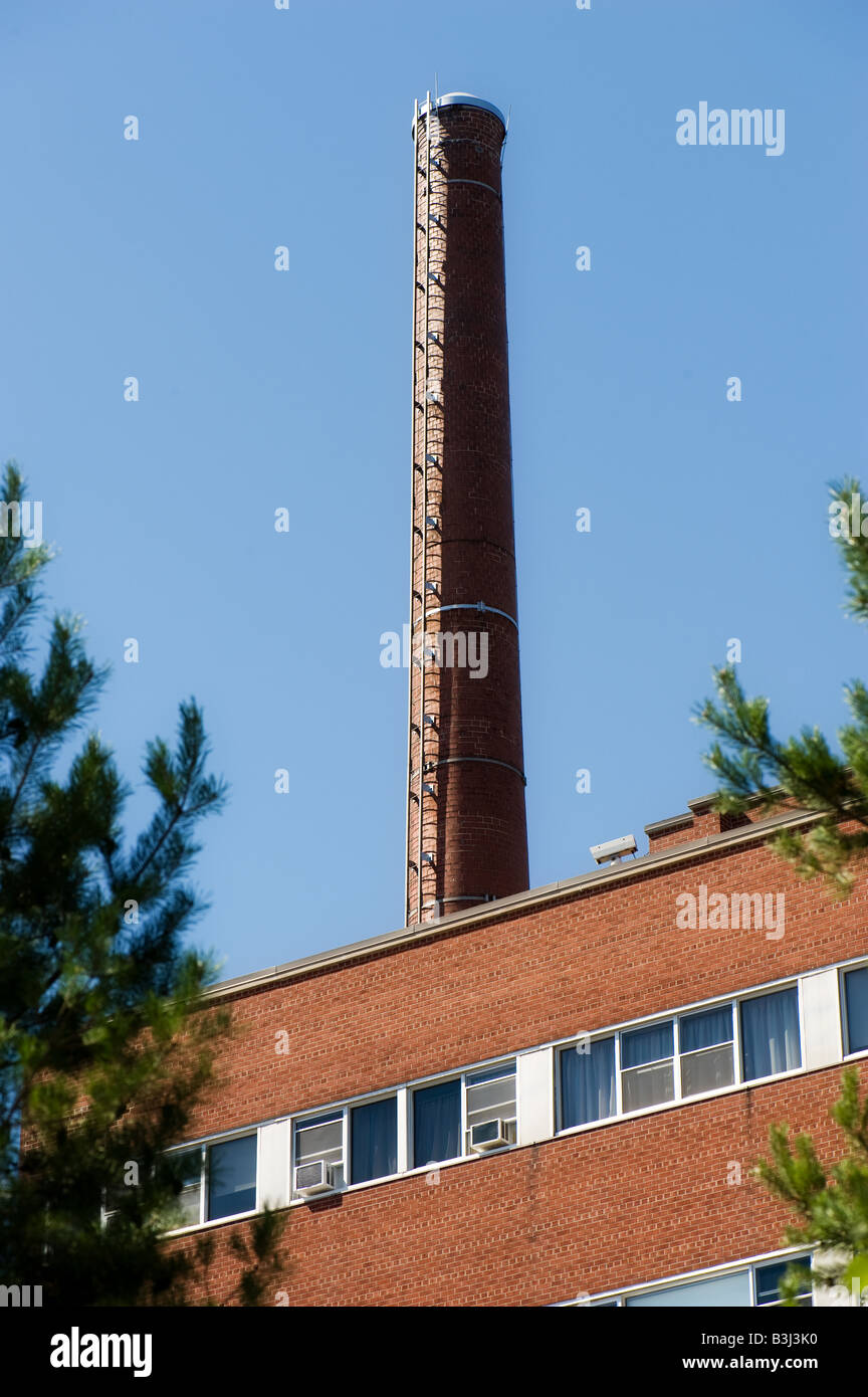 A large brick smokestack on a rooftop Stock Photo - Alamy