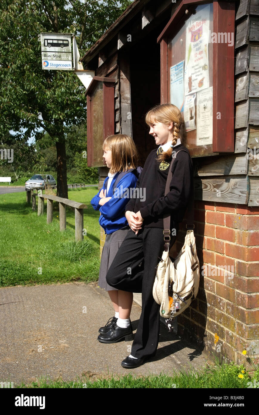 Children waiting at bus stop outside a bus shelter Stock Photo - Alamy