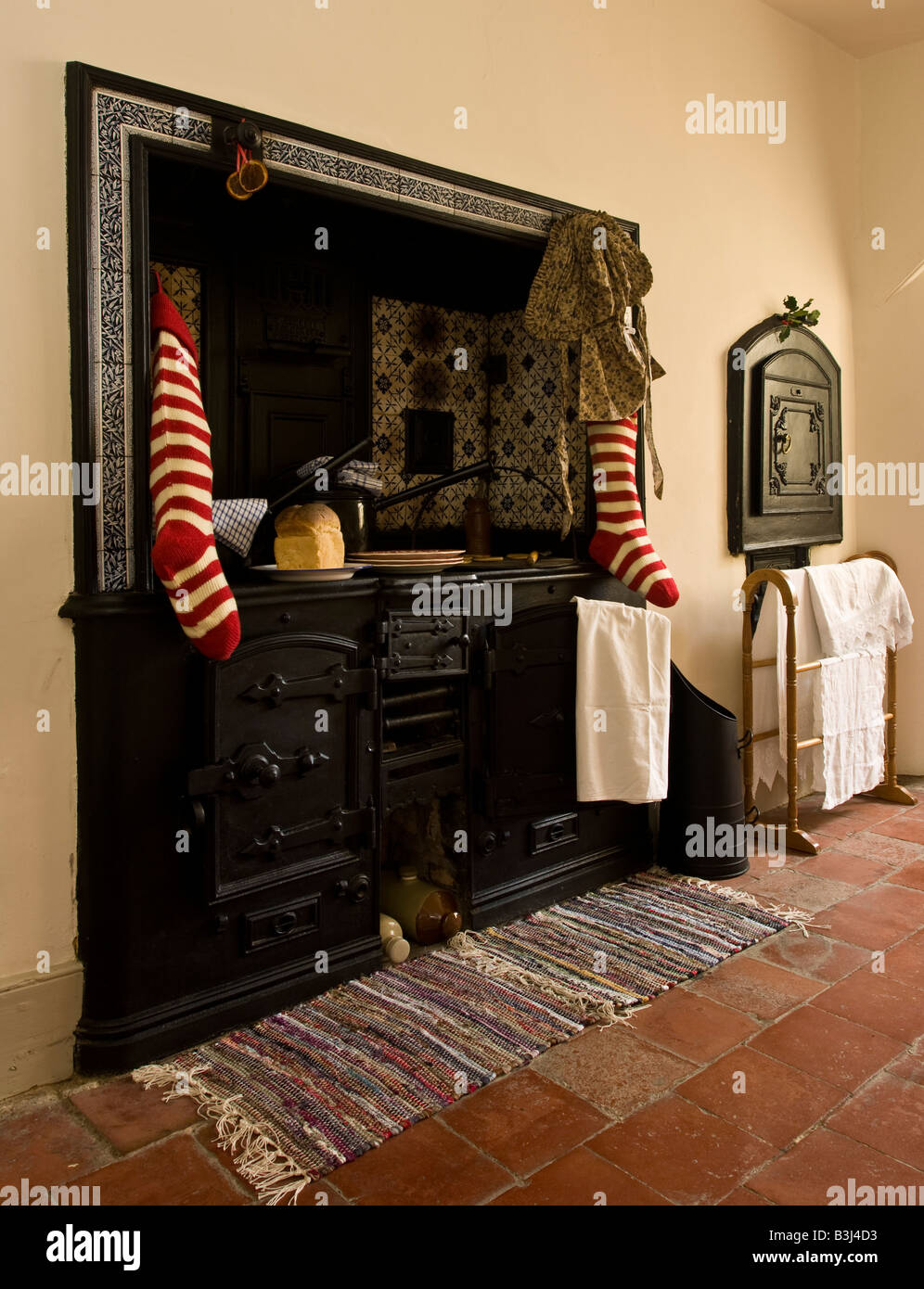 A traditional cast-iron cooker in a Victorian kitchen shown decorated ...