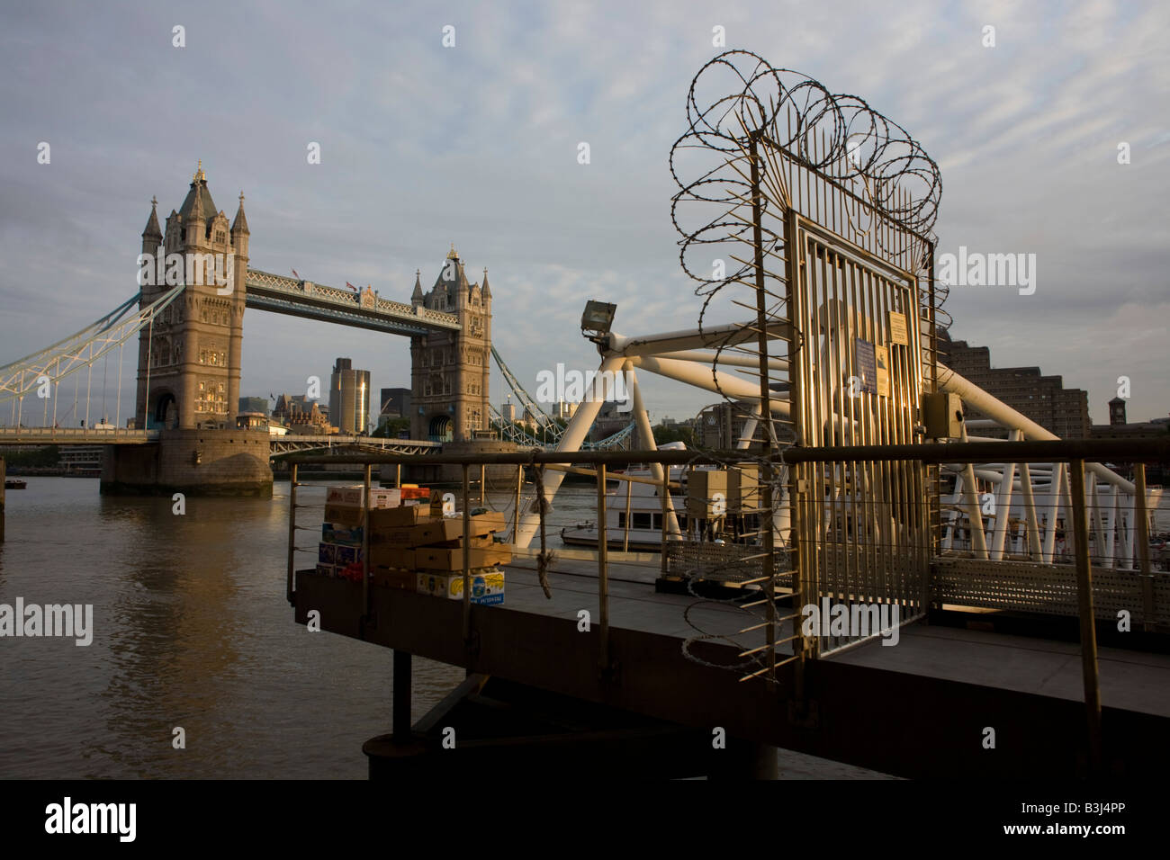 London's famous Tower Bridge with a secure jetty razor wire and stacked ...