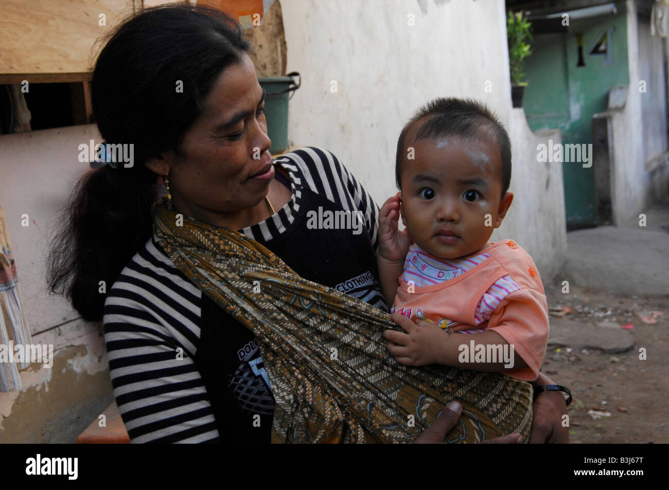 mother with child, slum neighbourhood in kuta , bali , indonesia Stock ...