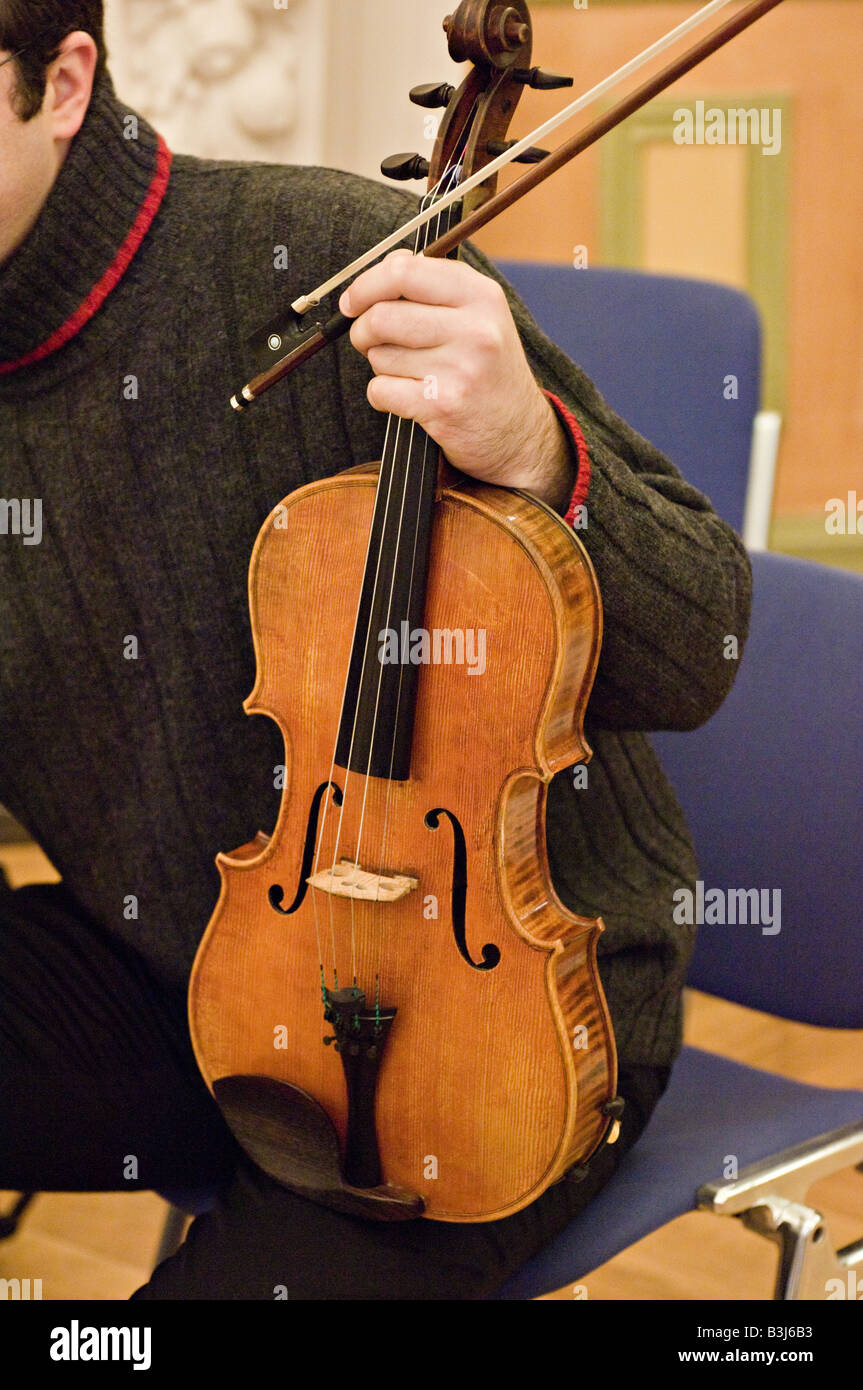 Musician holding a viola Stock Photo - Alamy