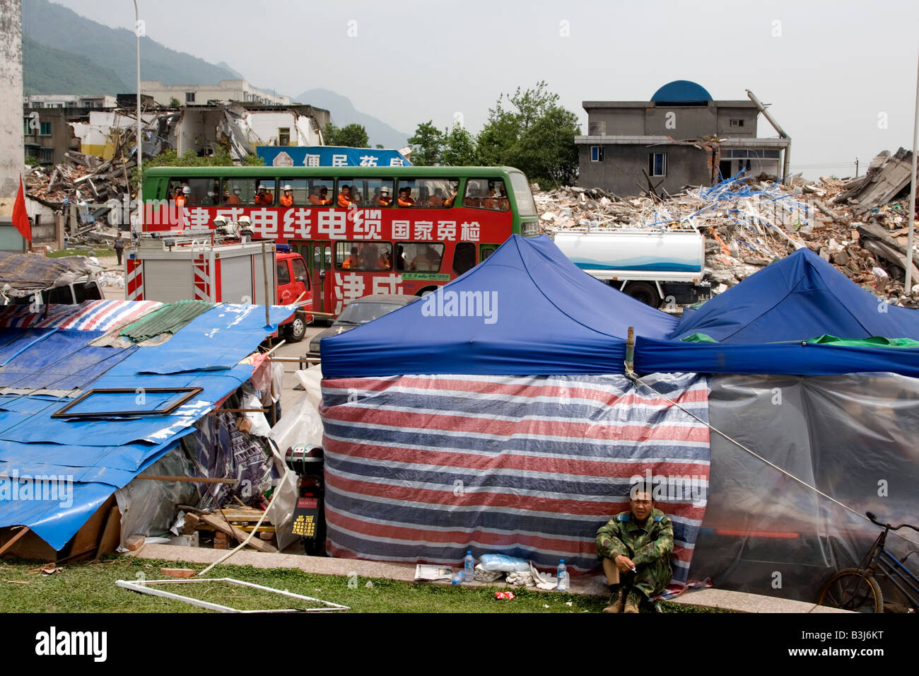 Makeshift tents house survivors and rescue personnel at an area hit by ...