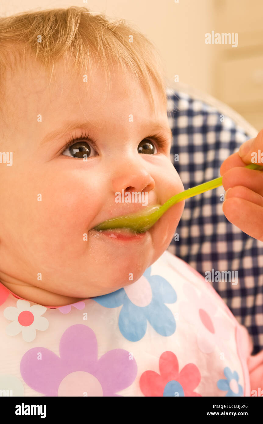 baby girl being spoon fed Stock Photo - Alamy