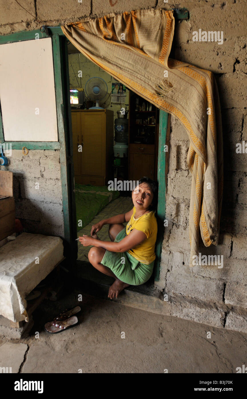slum in backstreets of kuta(behind paradise), poor slum girl making the ...