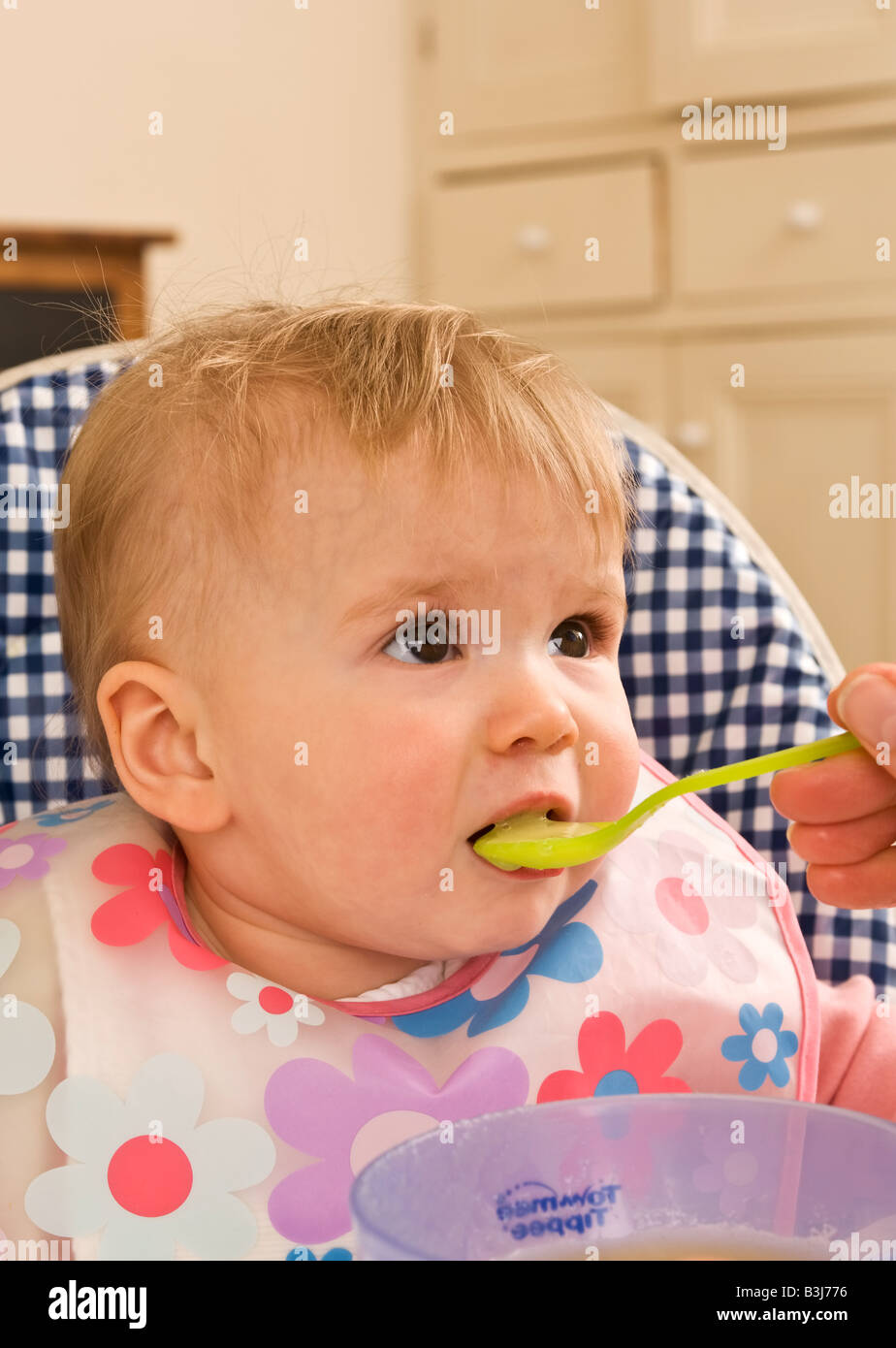 baby girl being spoon fed Stock Photo - Alamy