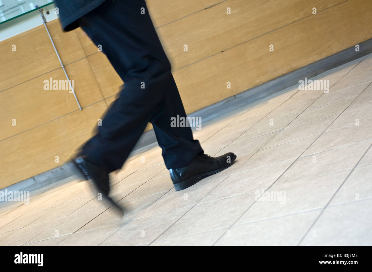 blurred suited legs walking Stock Photo - Alamy