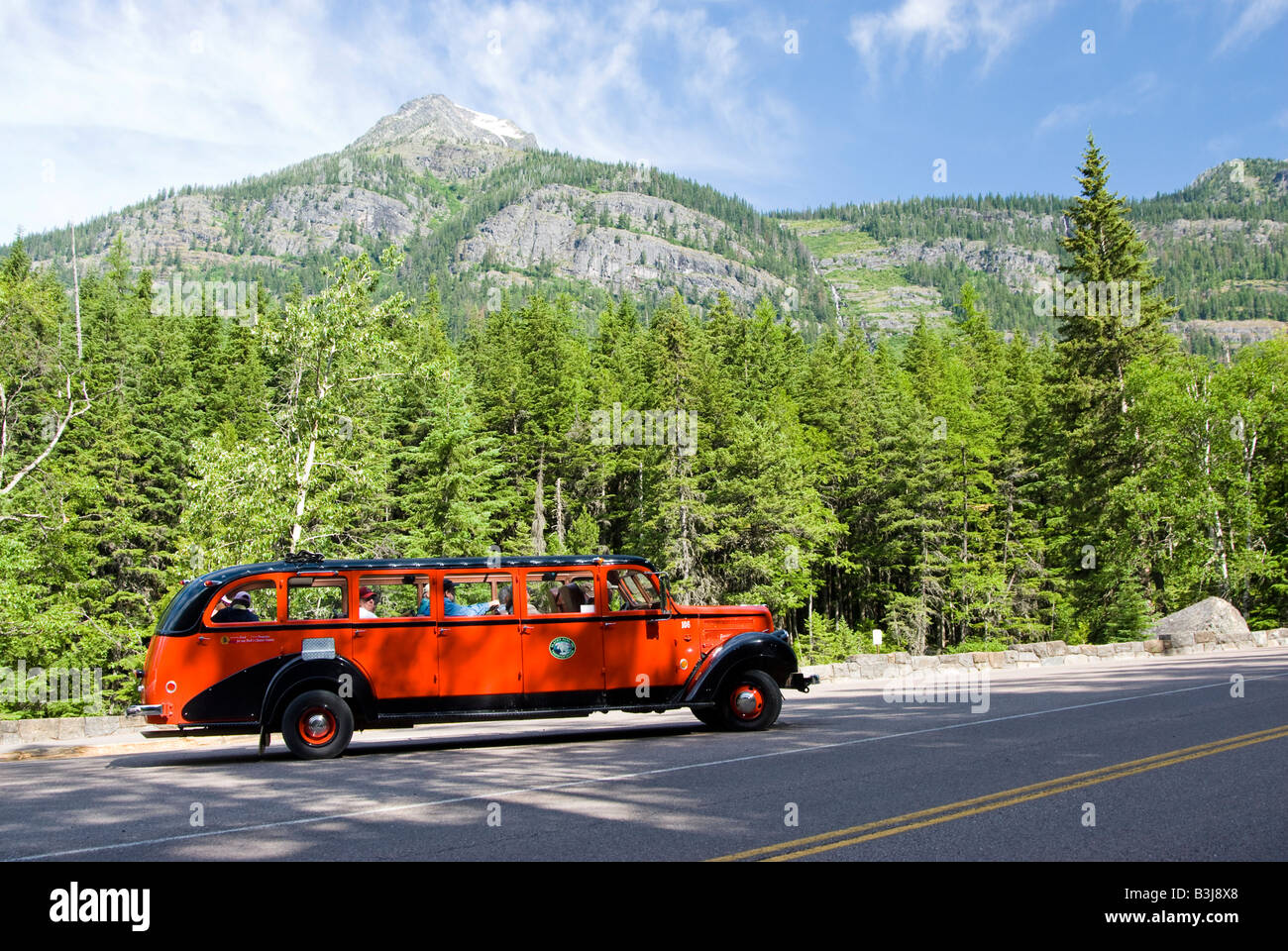 Propane powered red tour bus in Glacier National Park Montana Stock ...