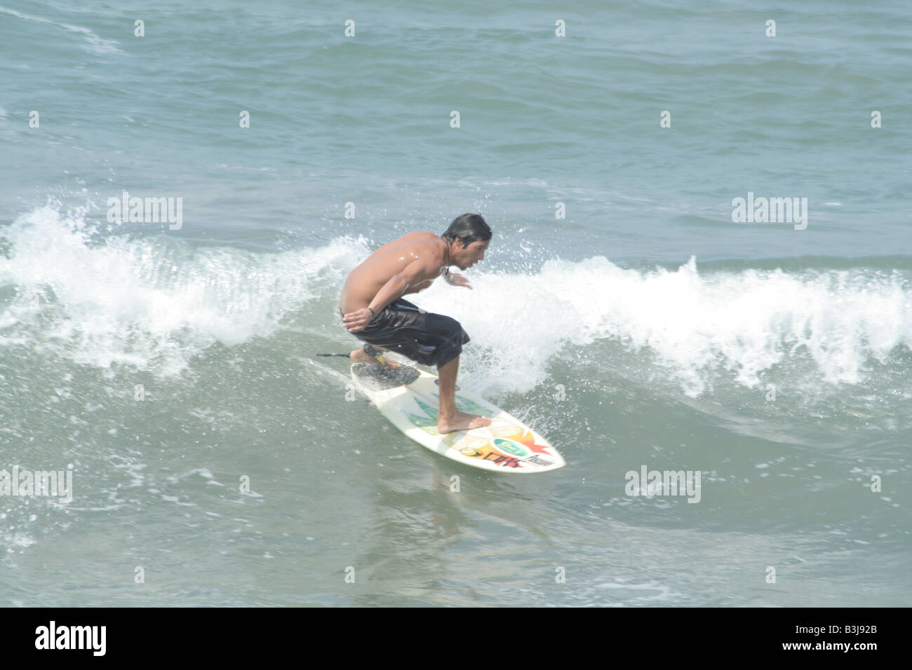 surfer riding a perfect wave and doing tricks Stock Photo - Alamy
