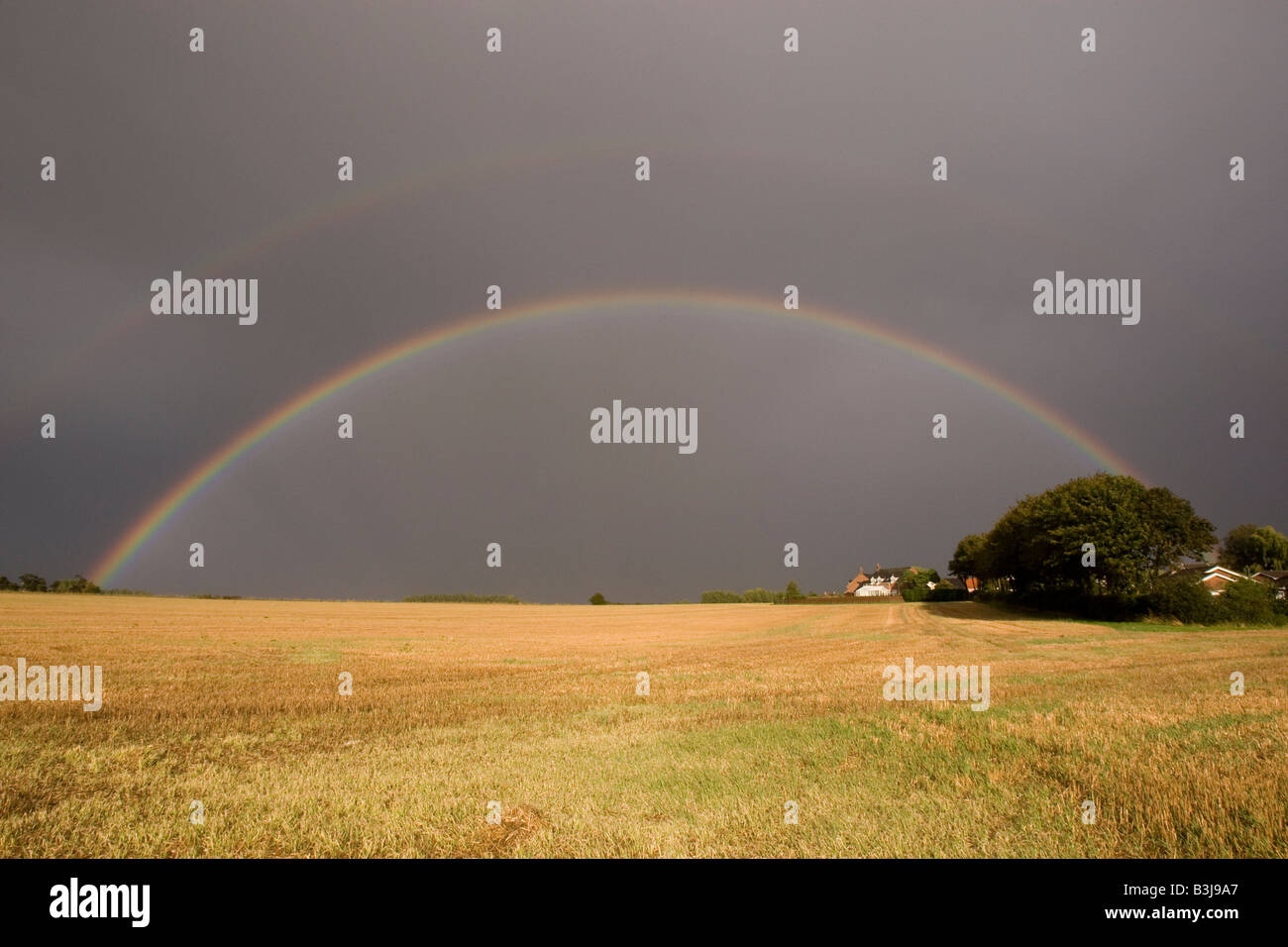 Complete rainbow over fields, countryside Stock Photo - Alamy