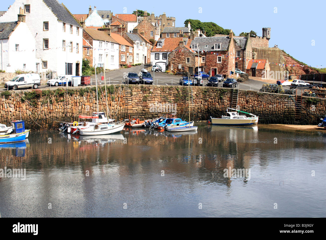 fishing boats in crail harbour with village in background. room for ...