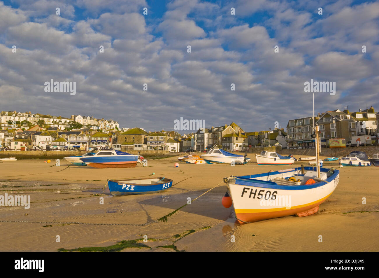 cornish fishing boats at low tide in the harbour at St Ives Cornwall ...