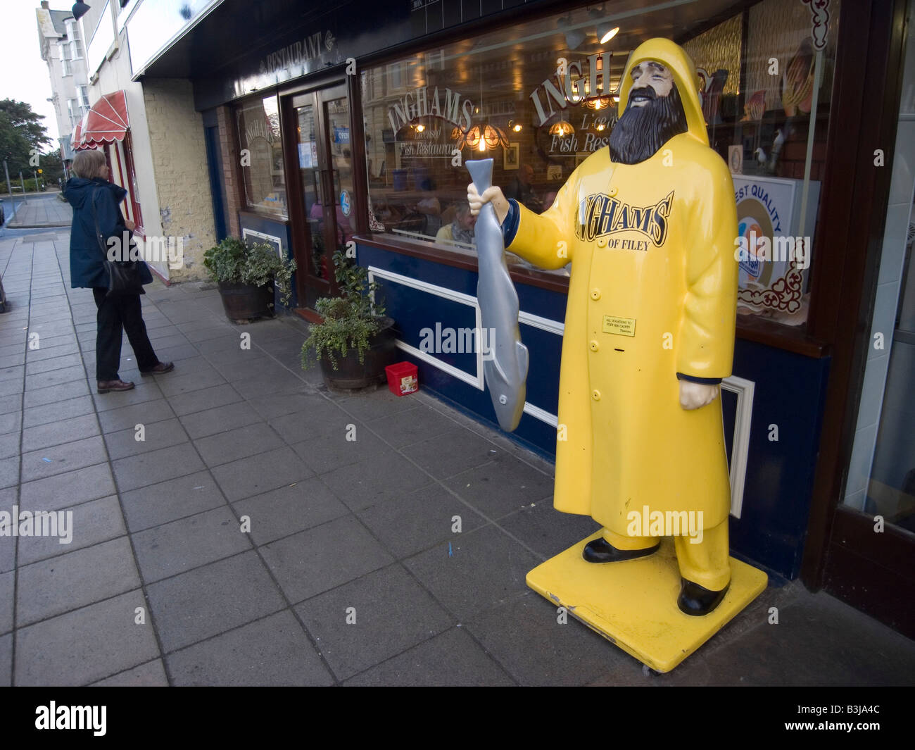 A yellow mannikin in the form of a fisherman in yellow oilskins at ...