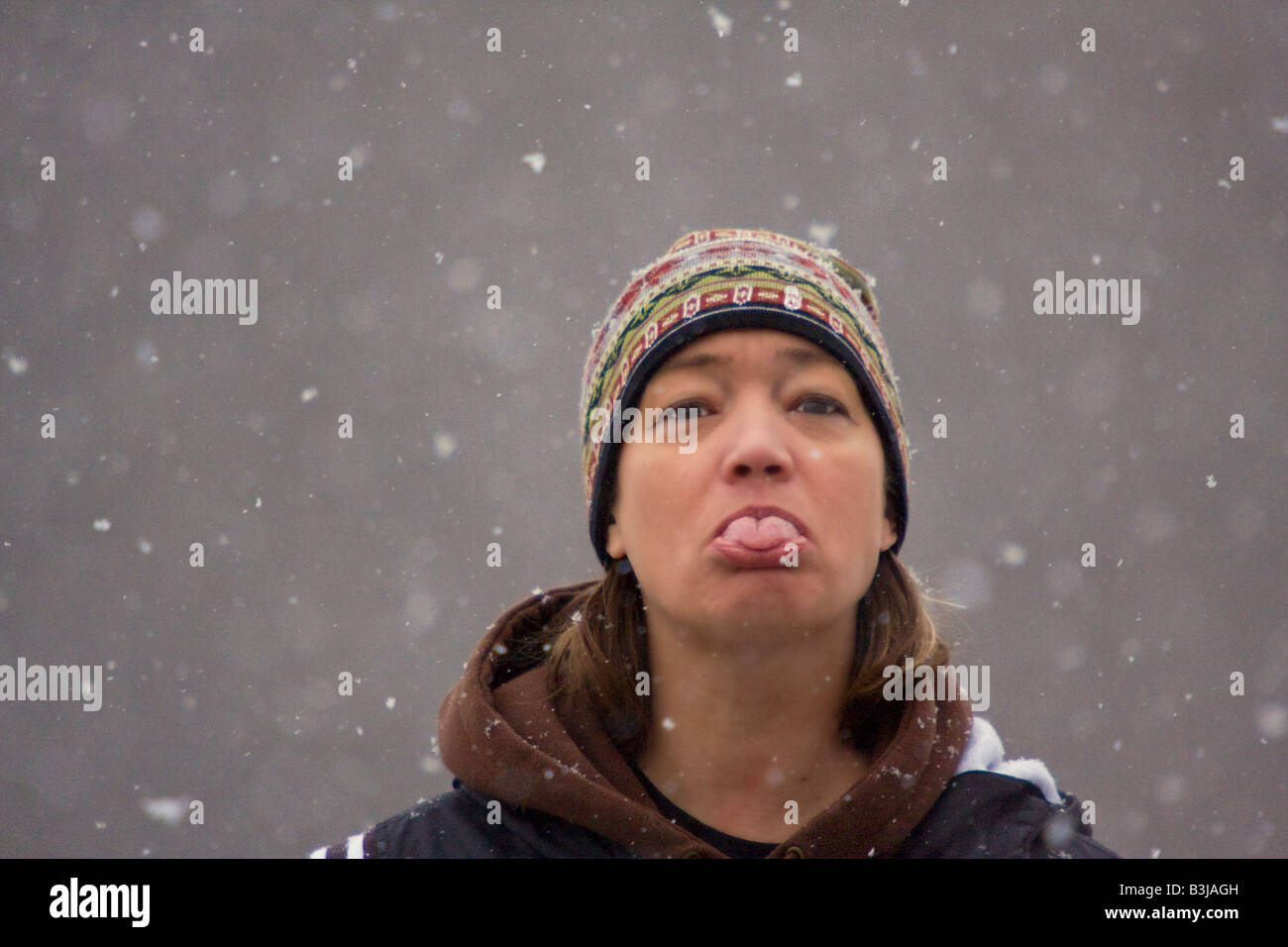 Woman catching snowflakes on her tongue Stock Photo - Alamy