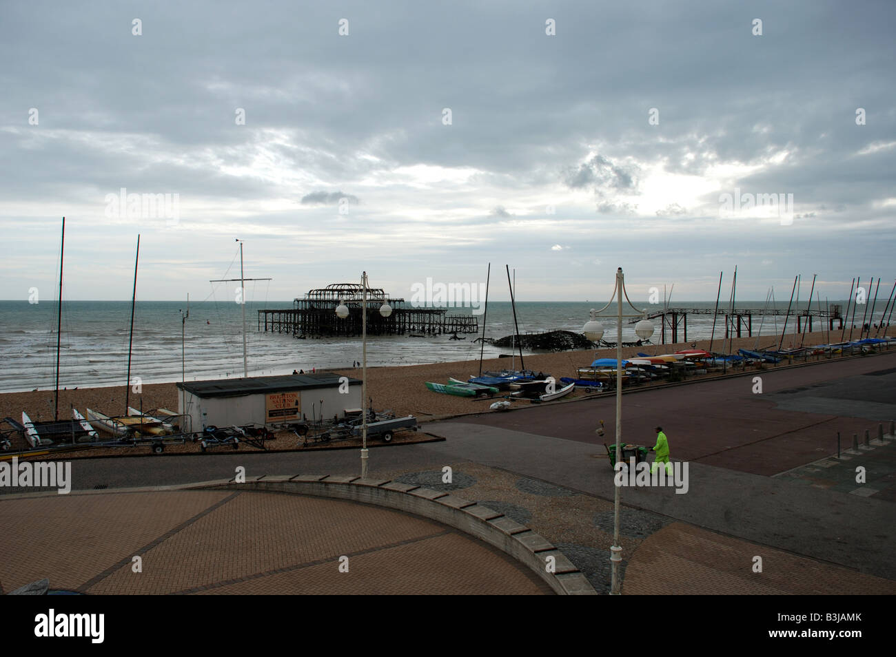 Brighton beach promenade with dustman in green overalls walking and the ...