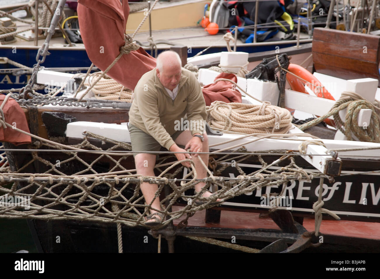 Sailor working on rigging on the Glaciere of Liverpool sailing ship at ...