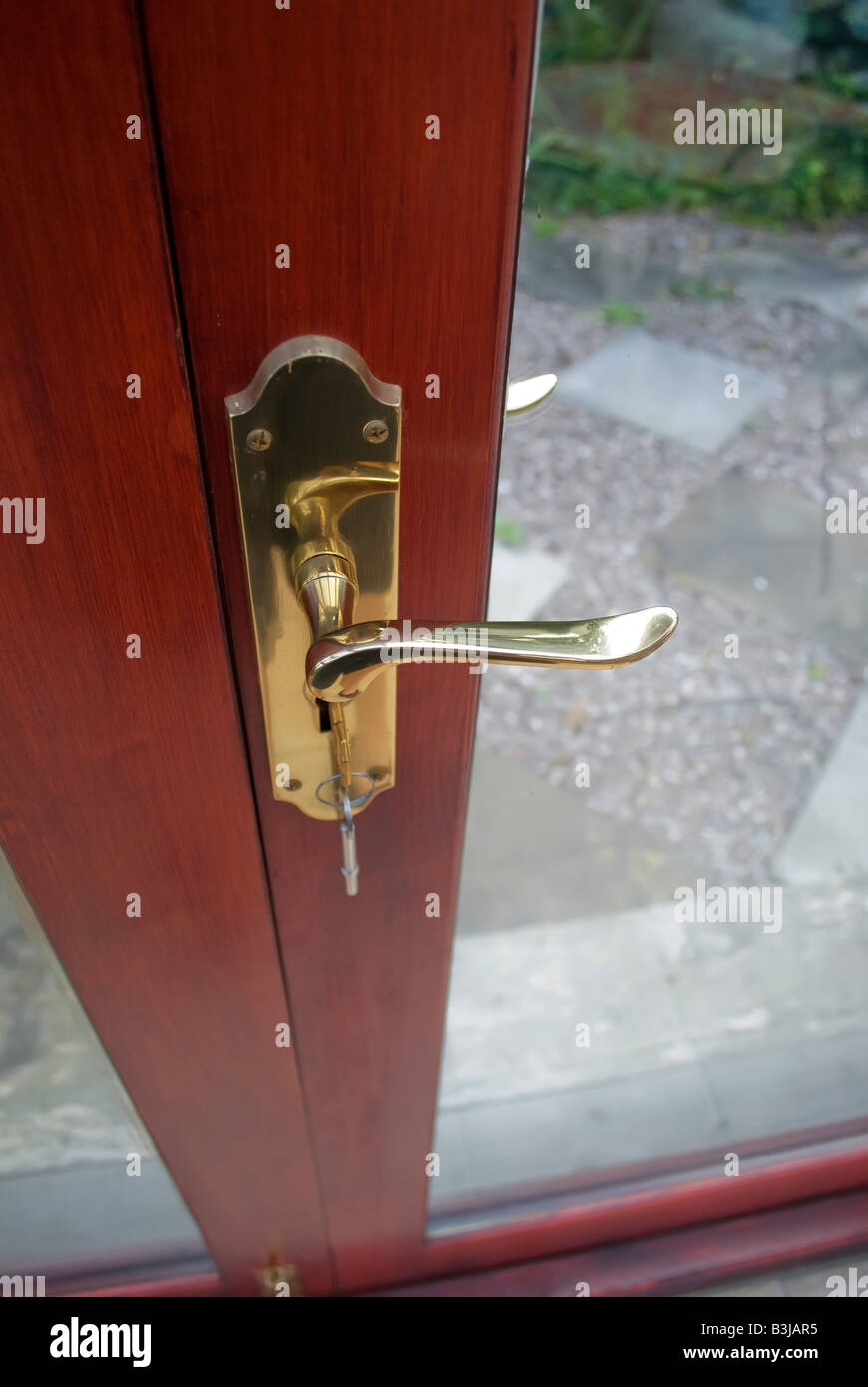 A key in door illustrating security Stock Photo - Alamy