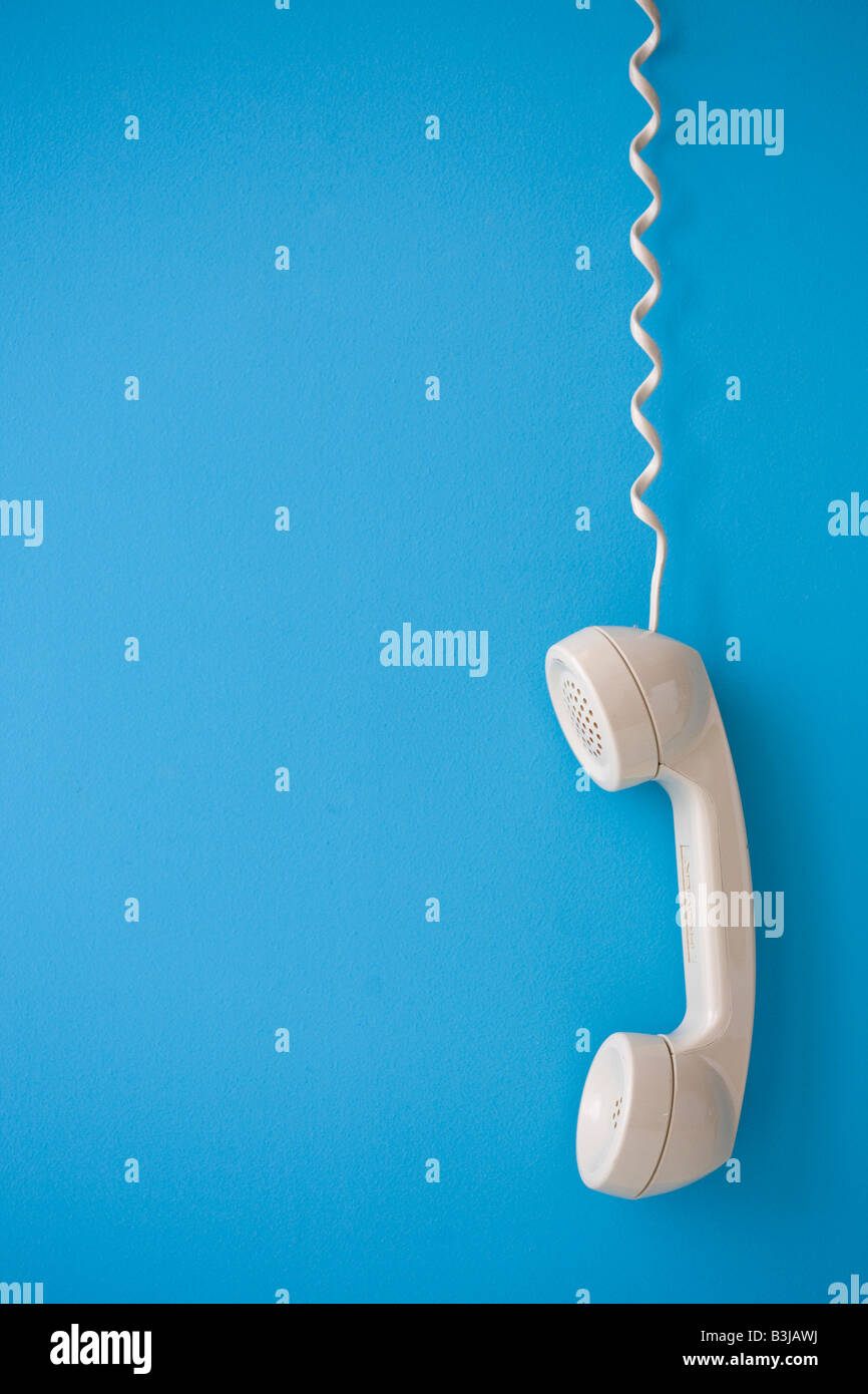 telephone receiver hanging off the hook Stock Photo - Alamy