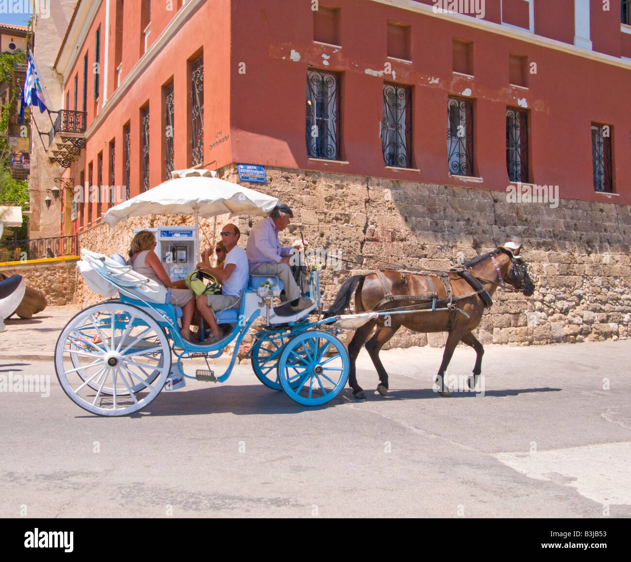 People taking a tour of Chania Crete in a horse drawn carriage Stock ...