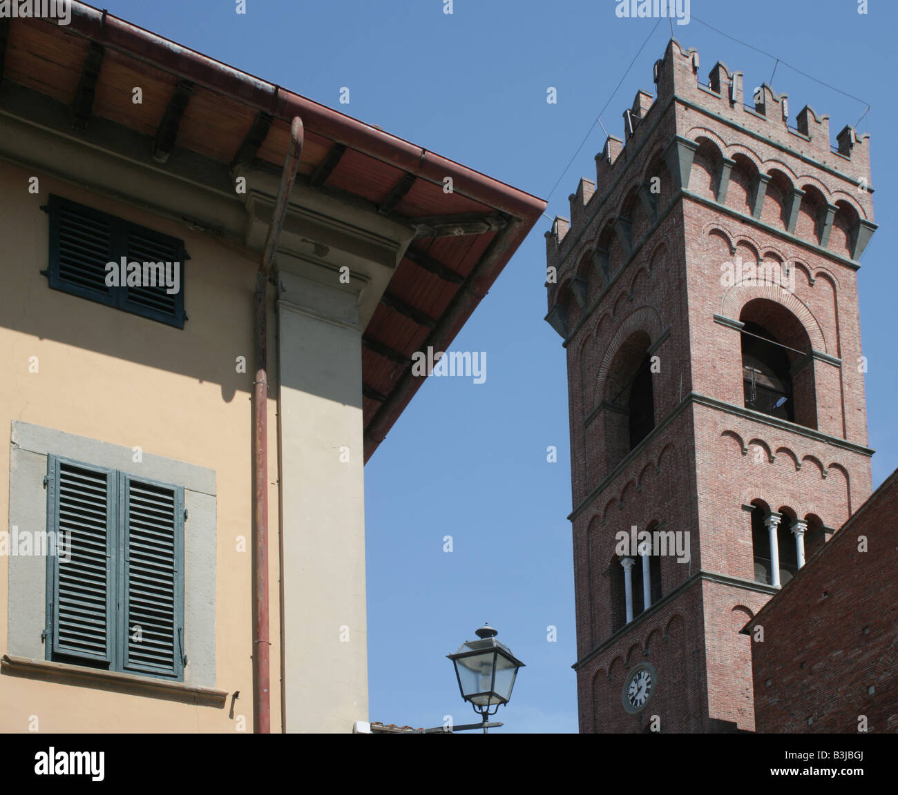The brick clock tower in the hilltop Tuscan village of Monte Carlo ...