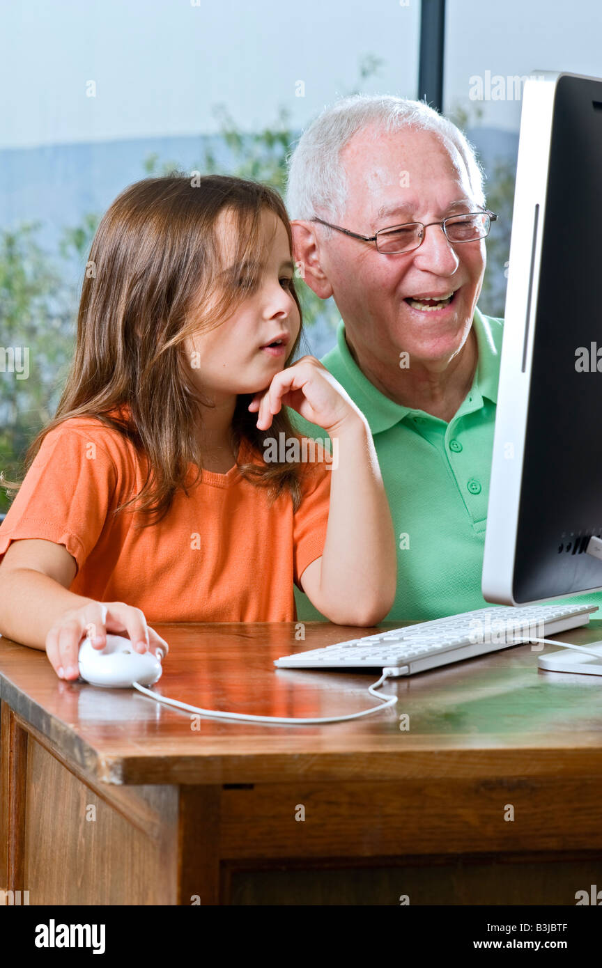 grandfather and granddaughter with computer at home Stock Photo - Alamy