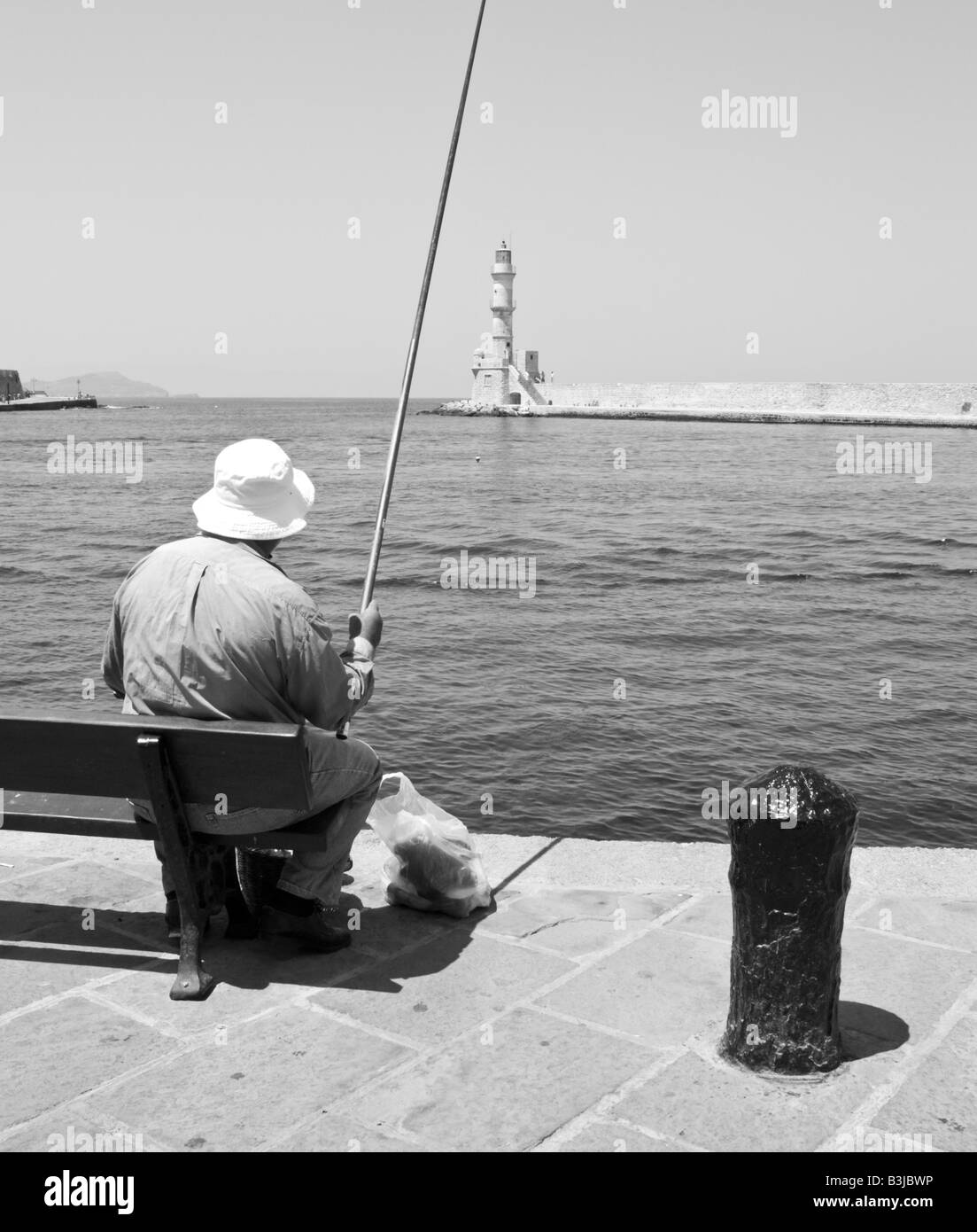 Person fishing Chania harbour Crete Stock Photo - Alamy
