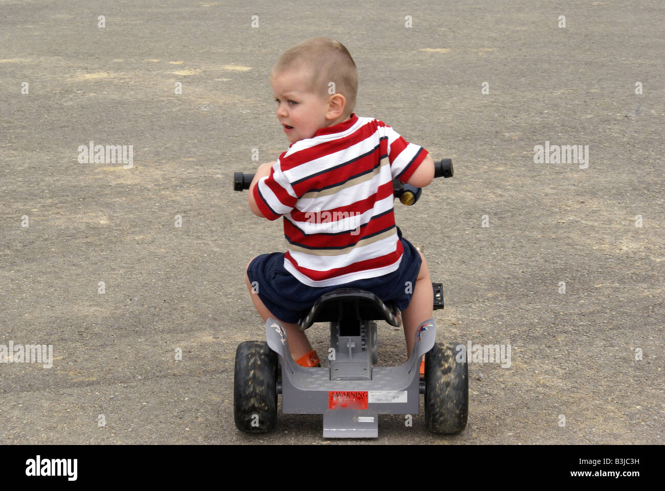 Boy riding tricycle in front hi-res stock photography and images - Alamy