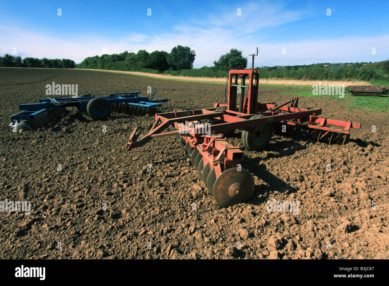 Farm equipment left in a field Stock Photo - Alamy