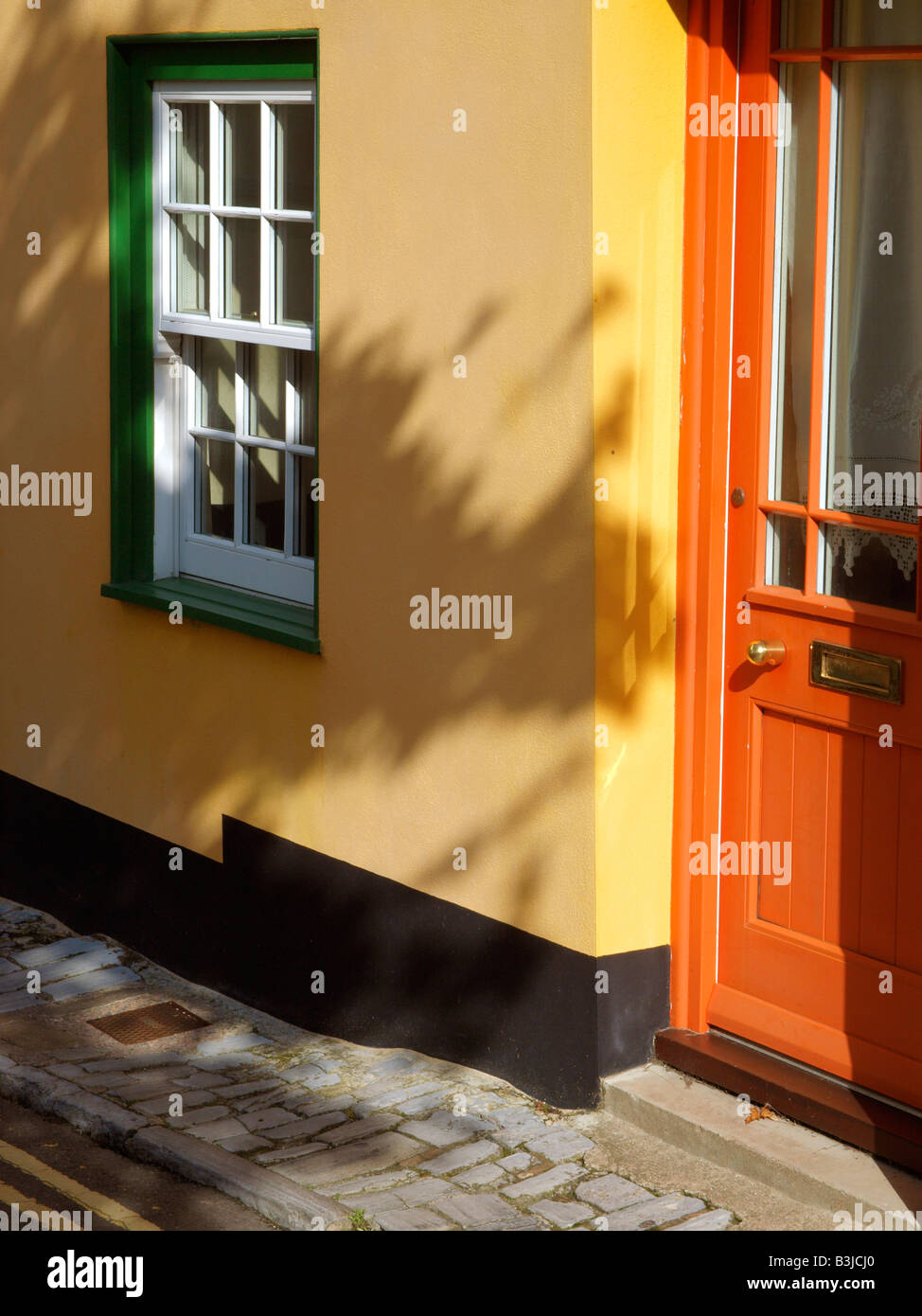 Colourful sunlit house Stock Photo - Alamy