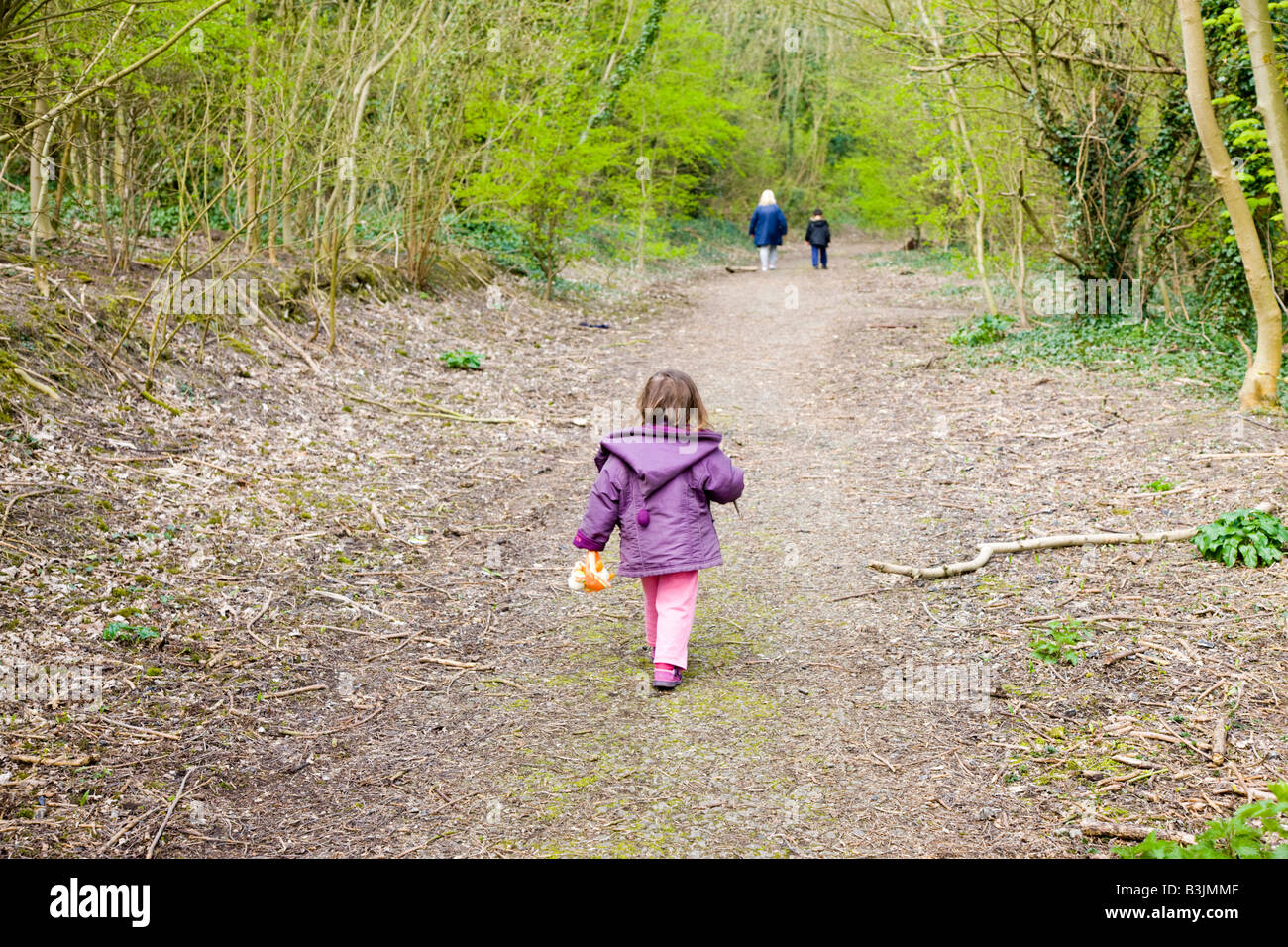 Family going for a walk in the forest Stock Photo - Alamy