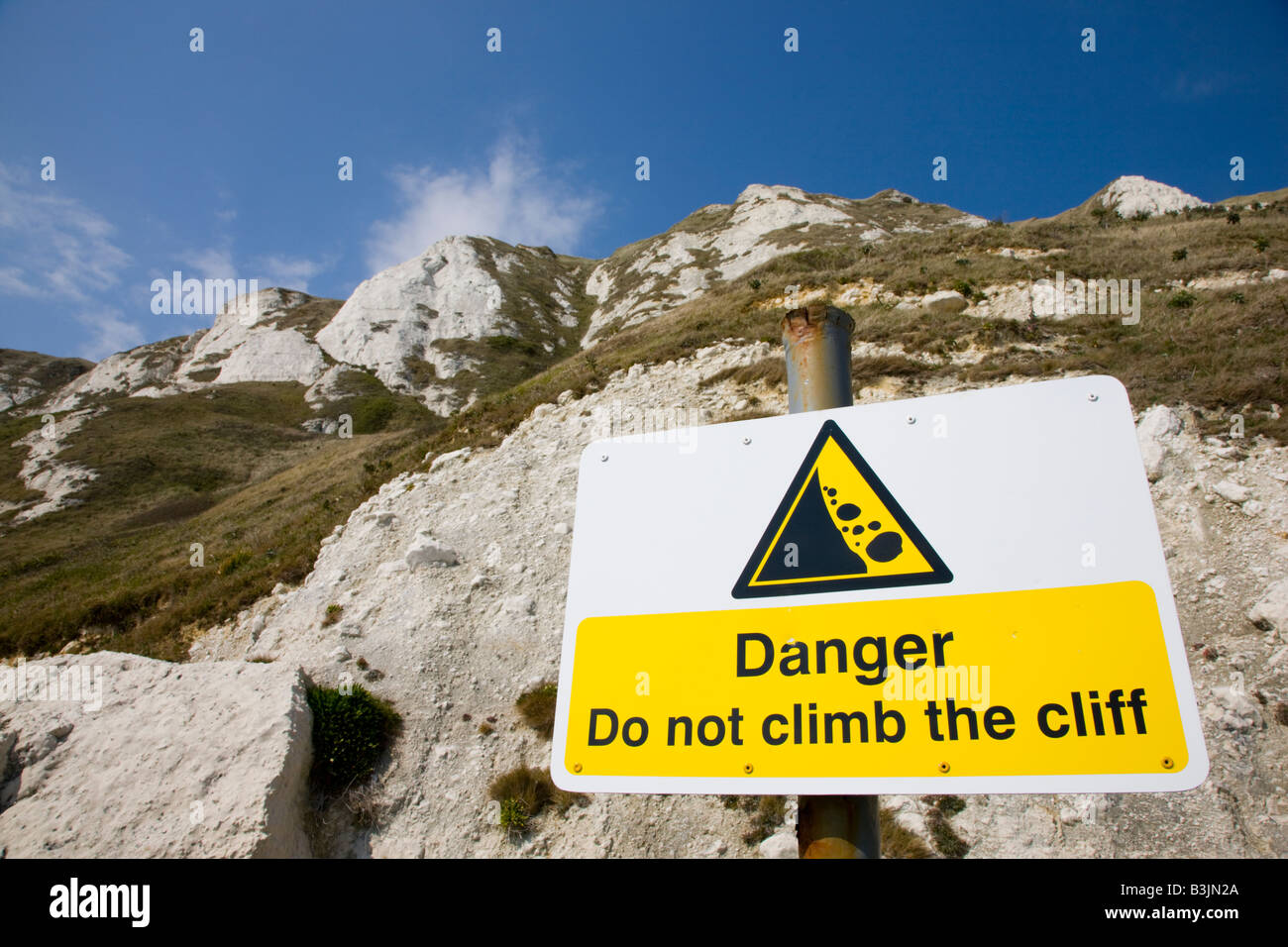 Sign stating Danger Do not climb this cliff Stock Photo - Alamy