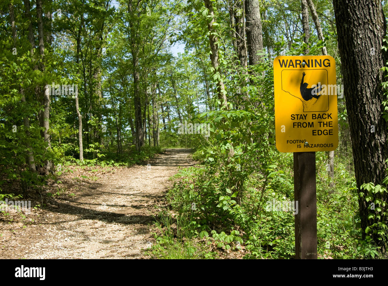 Hazardous footing warning sign on hiking trail behind the Tyler Bend ...